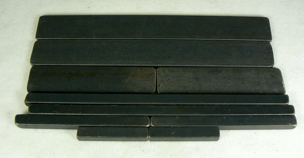 How can an operator hold sheet material flat on the laser table?